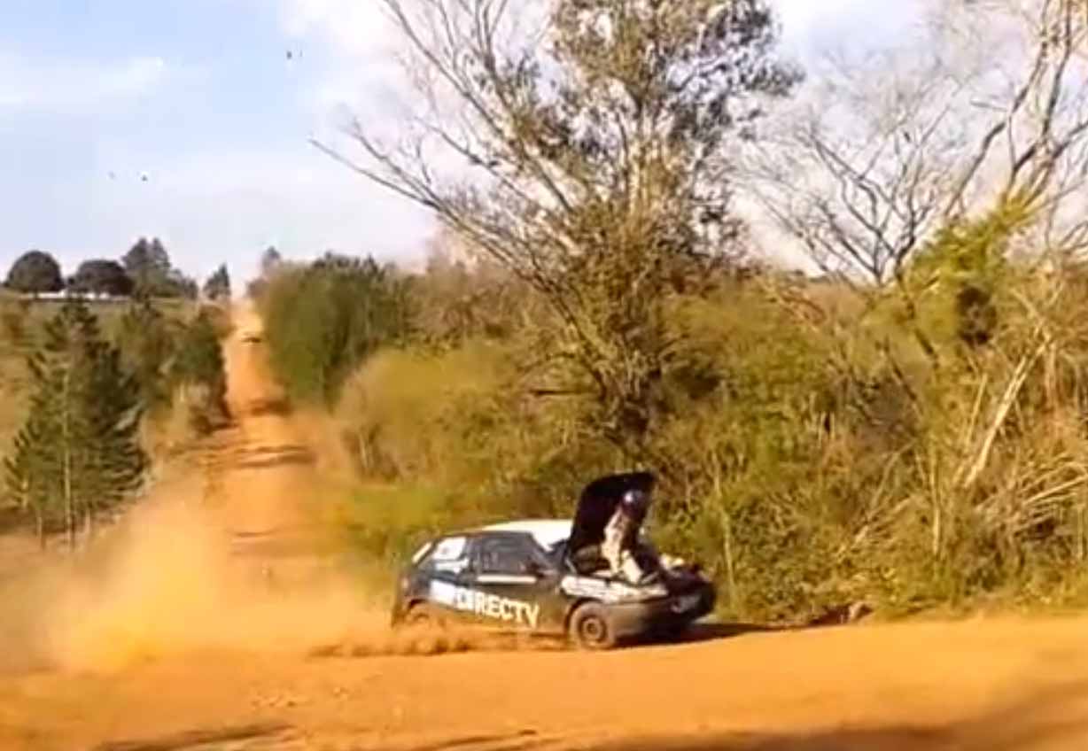 Rally Co-Driver Sits On The Engine Controlling the Throttle